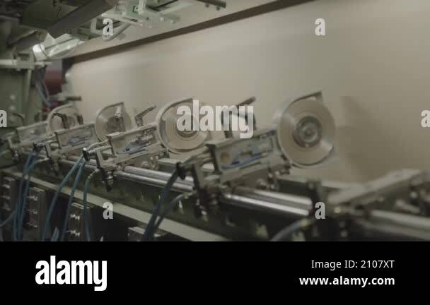 Winding machines placed on table in cardboard industry workshop ...