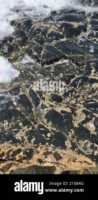 Ocean tides swirling in a rock pool on the beach Stock Video Footage ...