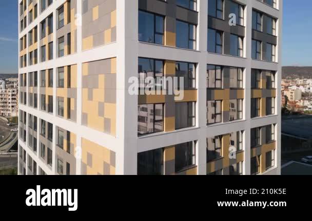 A high-rise building showcases sleek lines and a unique pattern on its ...