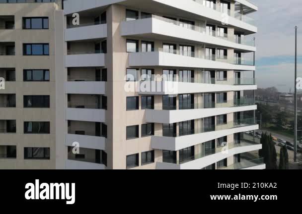 A contemporary residential structure features a unique wave-like facade ...