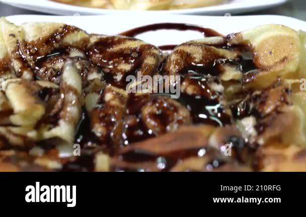 2 Roti topped with Chocolate sauce and sweetened condensed milk are ...
