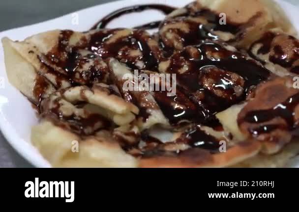 Roti topped with Chocolate sweetened condensed milk on it and ready to ...