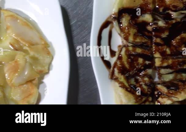 2 Roti topped with Chocolate sauce and sweetened condensed milk are ...
