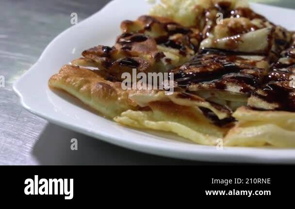 Roti topped with Chocolate sweetened condensed milk on it and ready to ...