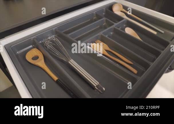 Different utensils in open desk drawer indoors, close up. Kitchen ...