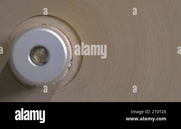 Huge cylinder winds paper webs into rolls at cardboard plant. Mechanism ...