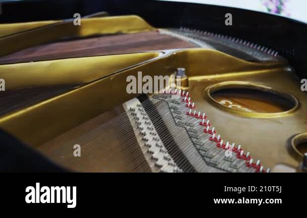 Open lid of grand piano reveals intricate strings and internal ...