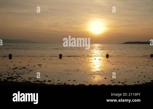 Time lapse of Sun behind clouds, colorful sky, clouds illuminated by ...