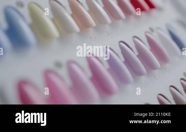 Close-up image of a variety of colorful nail polish samples arranged on ...