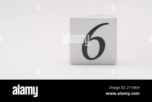 A minimalist white block featuring the number six, placed on a clean ...