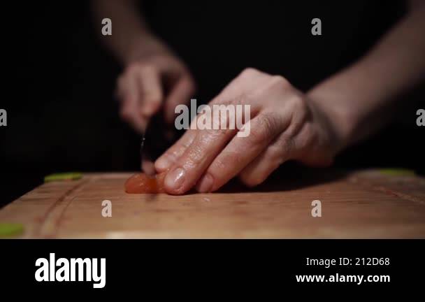 Close-Up of Hands Slicing Fresh Salmon Fillet on a Dark Background Stock Video Footage - Alamy