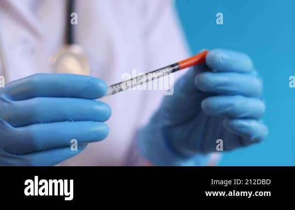 Insulin syringe. Nurse or doctor with syringe. Female hand in gloves ...