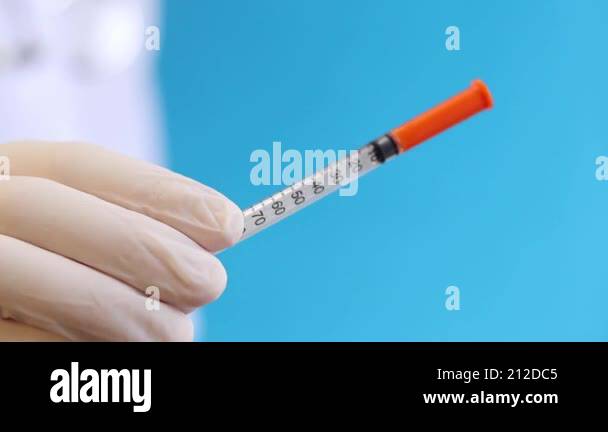 Insulin syringe. Nurse or doctor with syringe. Female hand in gloves ...