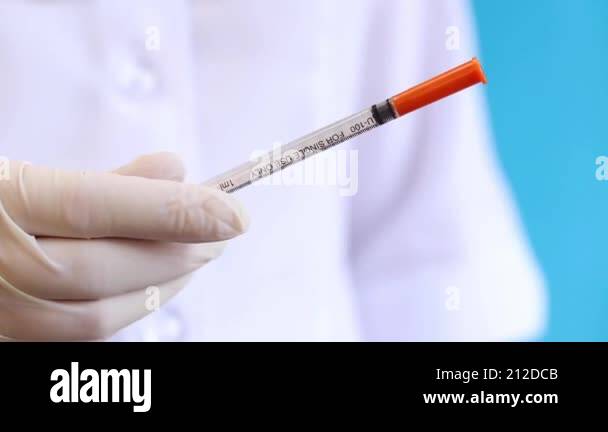 Insulin syringe. Nurse or doctor with syringe. Female hand in gloves ...
