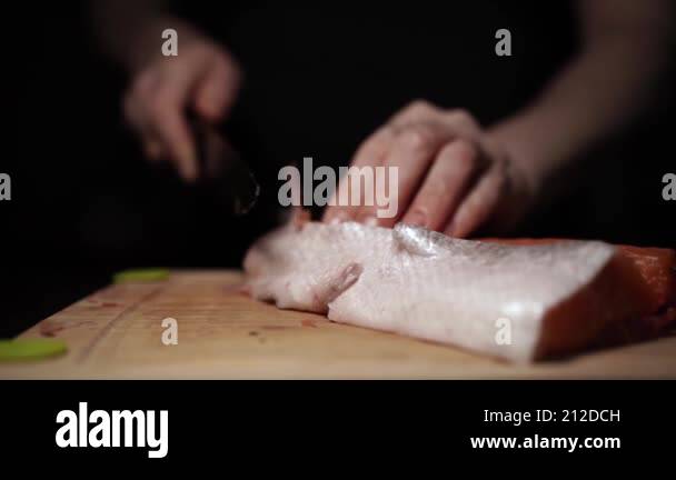 Close-Up of Hands Slicing Fresh Salmon Fillet on a Dark Background Stock Video Footage - Alamy