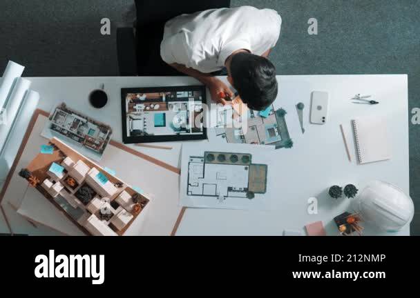 Top view of skilled civil engineer sitting and writing idea while ...