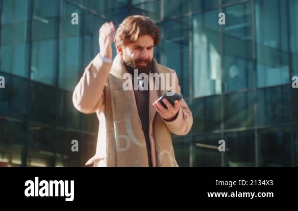 Upset unhappy Indian young man guy male using mobile smartphone bad ...