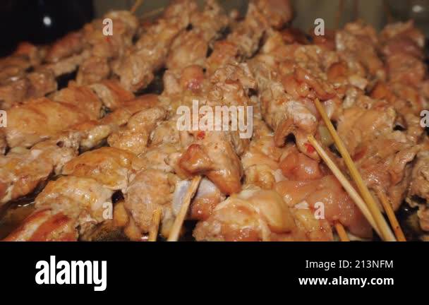 close up of the cooking process of homemade recipe chicken satay is ...