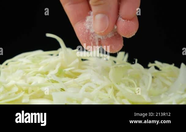 Sprinkling salt on chopped white cabbage macro slow motion Stock Video ...