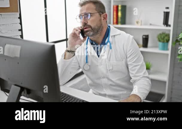 A mature, handsome hispanic man with grey hair, wearing a lab coat and ...