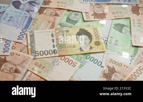 South korean banknotes scattered across a surface showcasing various ...