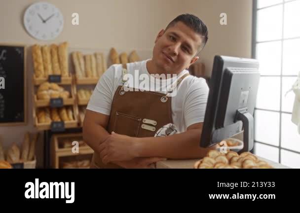 Young man with crossed arms in a bakery room standing behind the ...