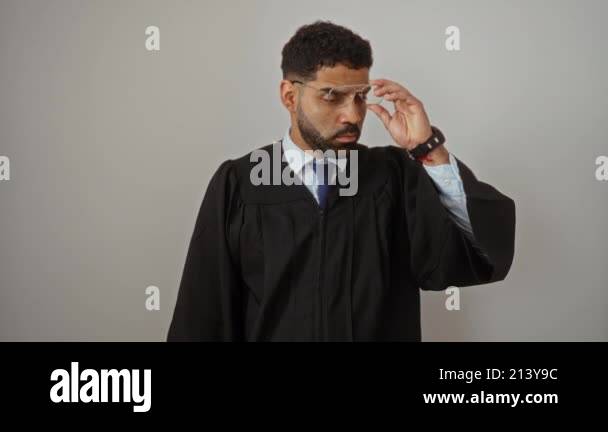 Judge in gown, young hispanic man standing with tired eyes, rubbing ...