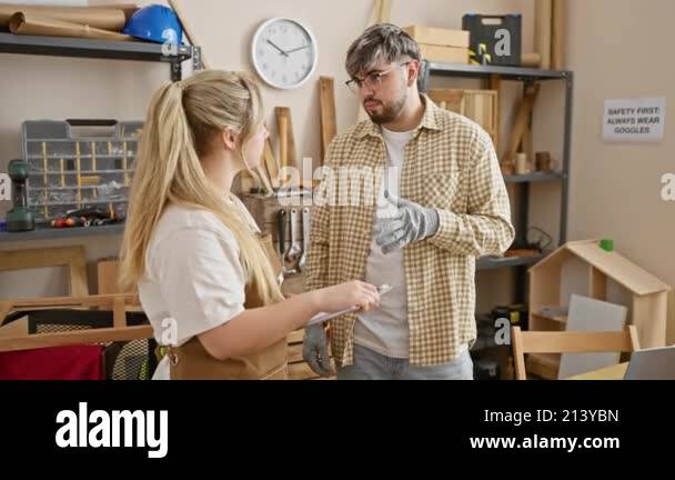 A man and woman, wearing casual clothes and protective gear ...