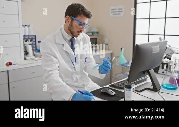 Hispanic scientist using computer and lab equipment in a modern laboratory setting Stock Video ...