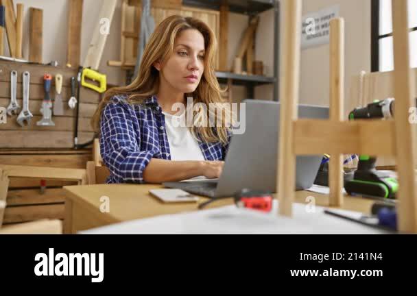 Shocked and afraid, young and beautiful latin woman sits on carpentry ...