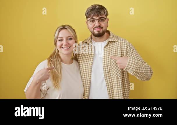 Beautiful couple ecstatically pointing together, joy marked on their ...