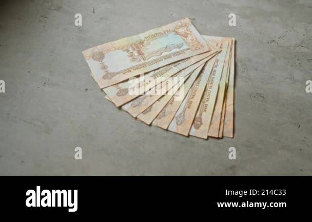 Stack of uae dirhams lying on a concrete surface showcasing banknotes ...