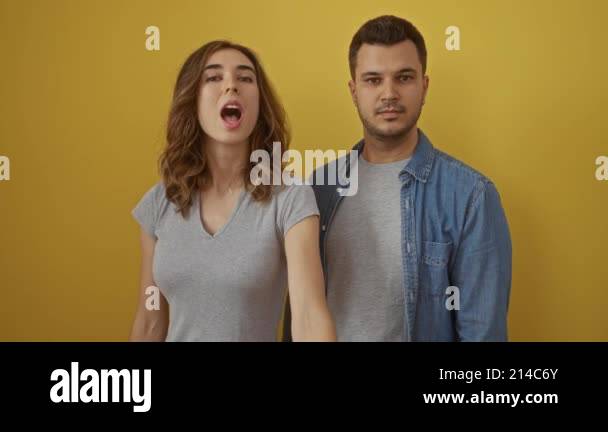 Man and woman together on yellow background, isolated, smiling ...