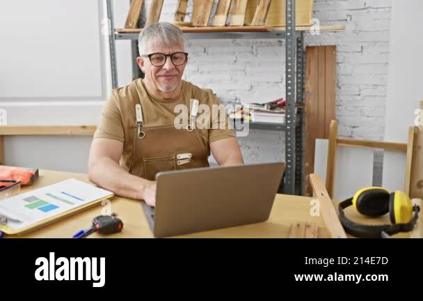 Cheerful middle age, grey-haired male carpenter, confidently smiling ...