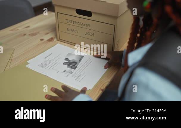 An african american woman reviews court documents, including a police ...