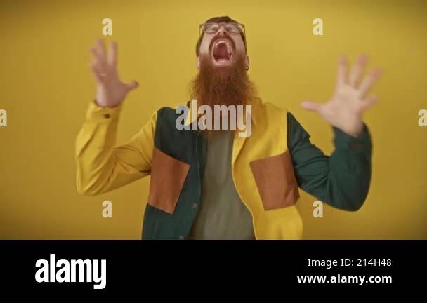 Frustrated redhead man in glasses kicks off a crazy rant, arms flailing ...