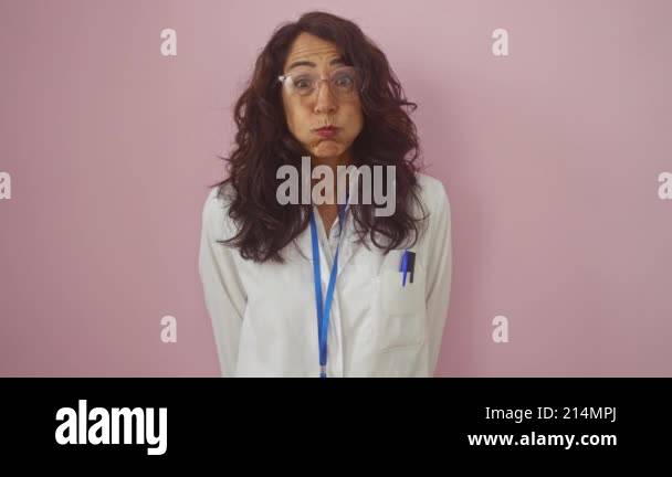 Hispanic middle aged woman scientist puffing up cheeks over inflated ...