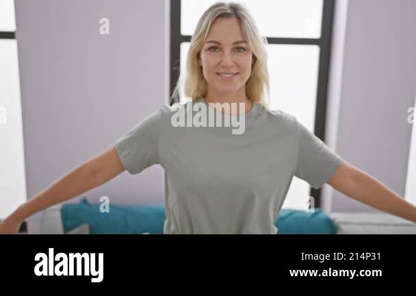 Relaxed young woman in casual attire enjoying comfort on a turquoise ...