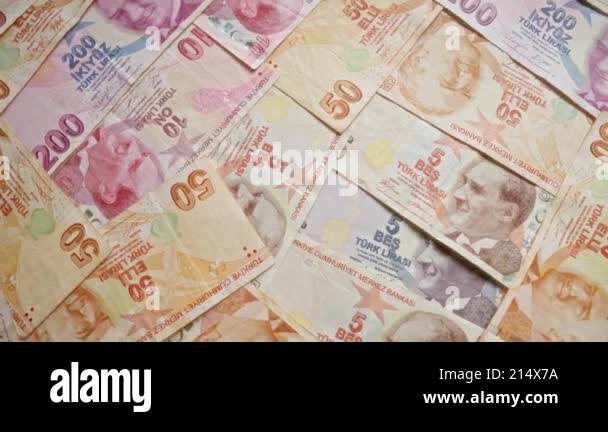 Turkish lira banknotes in various denominations spread across a surface ...
