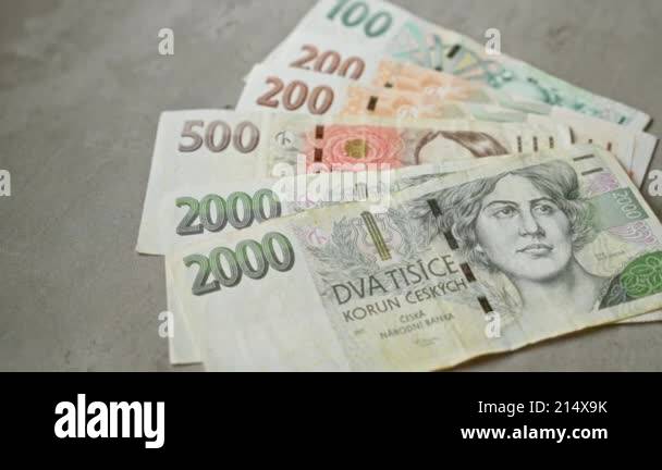 Czech koruna banknotes placed on a concrete surface showcasing various ...