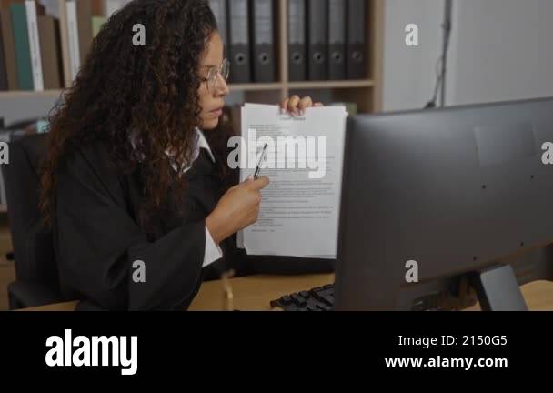 Female judge with curly hair in an office showing legal documents ...
