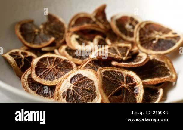 Close-up of a bowl filled with dried citrus fruit slices showcasing ...