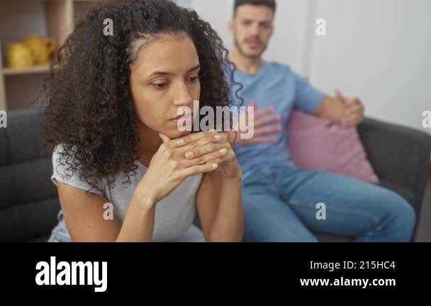 Worried woman and man having a discussion in a modern living room ...