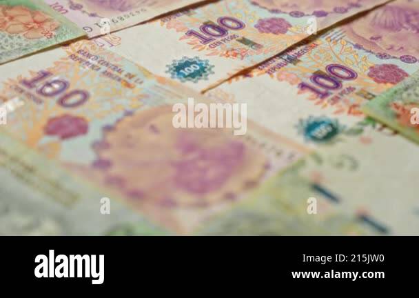 Argentinian banknotes laid out showing colorful 100 pesos depicting ...