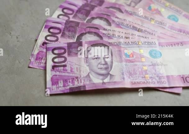 Philippine banknotes displayed on a concrete surface showcasing ...