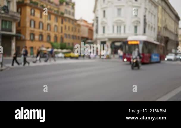 Blurred red bus driving down a historic street in rome, italy with ...