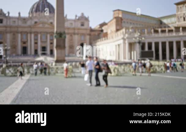 Blurred people standing in saint peter's square with the vatican ...