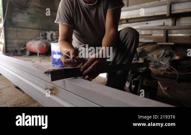 Male arms of professional repairman measuring metal detail with plastic ...