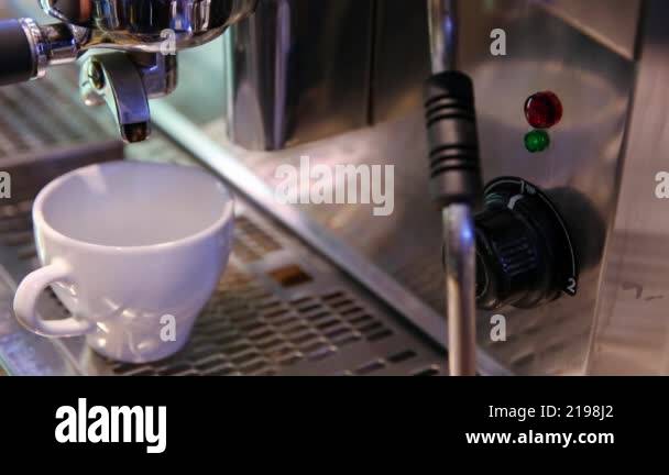 A detailed view showcasing an espresso machine featuring various dials ...