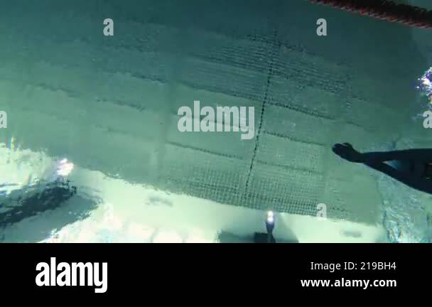 sportswoman swimmer in a tracksuit, in diving goggles, in a swimming ...